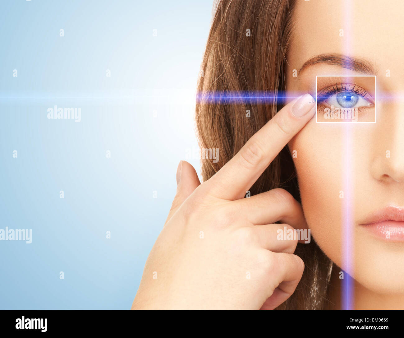 beautiful woman pointing to eye Stock Photo - Alamy
