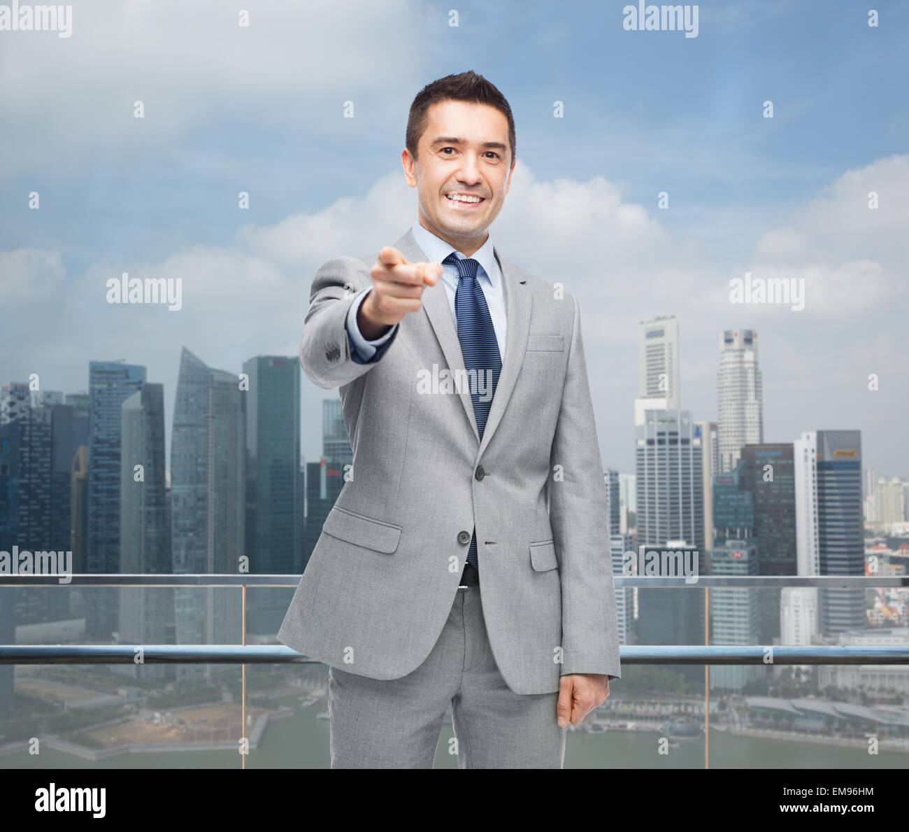 Businessman pointing smiling hi-res stock photography and images - Alamy