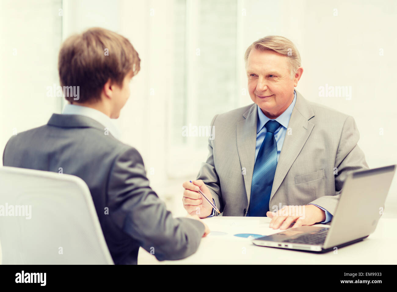 older man and young man having meeting in office Stock Photo - Alamy