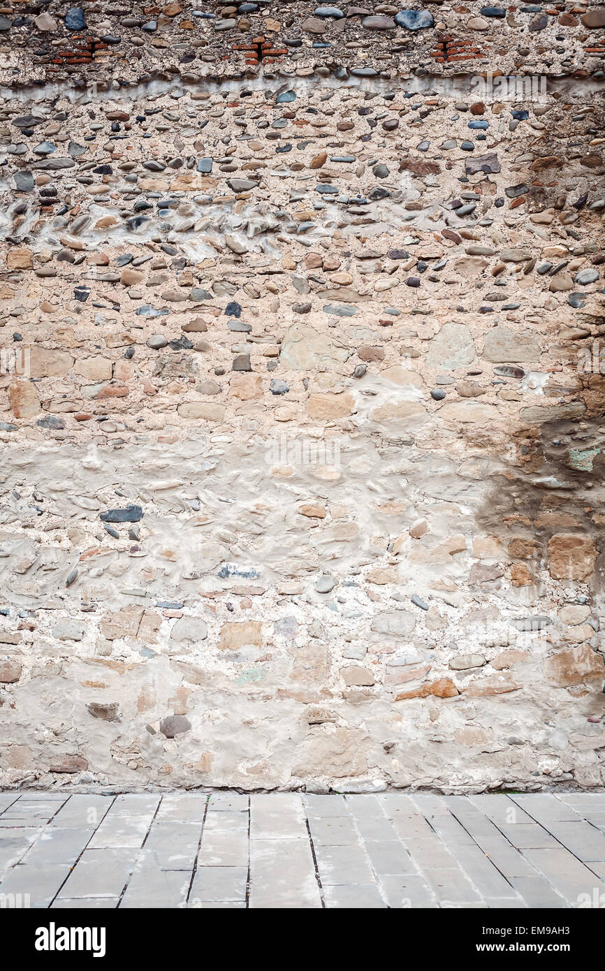 Wall of stones and pavement Stock Photo - Alamy