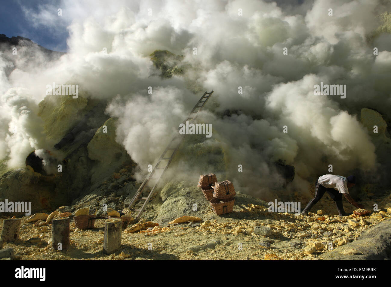 Sulphur mines Kawah Ijen, East Java, Indonesia. Miner collects sulphur ...