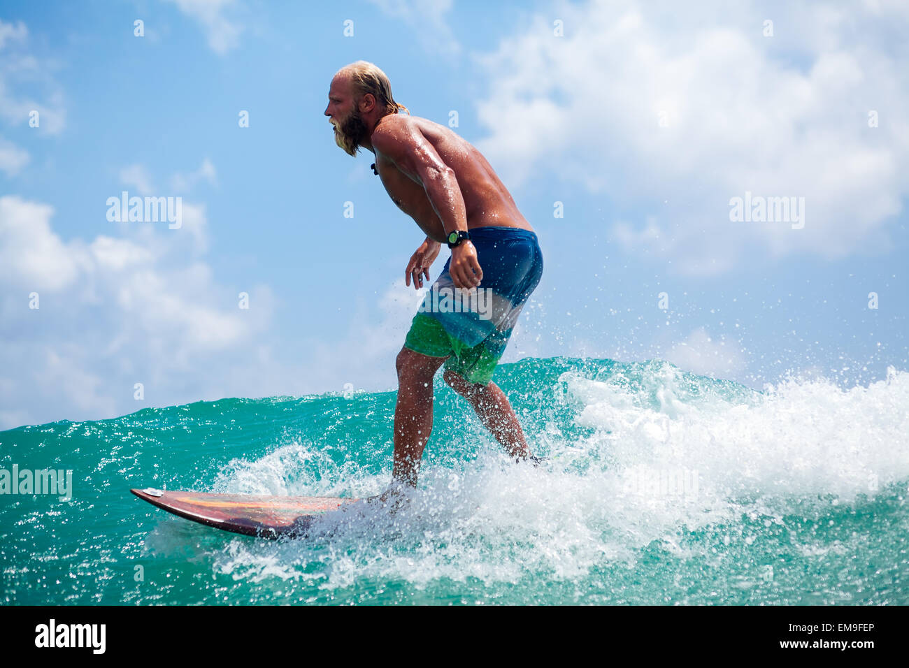 man with beard surfing wave splash actively Stock Photo - Alamy