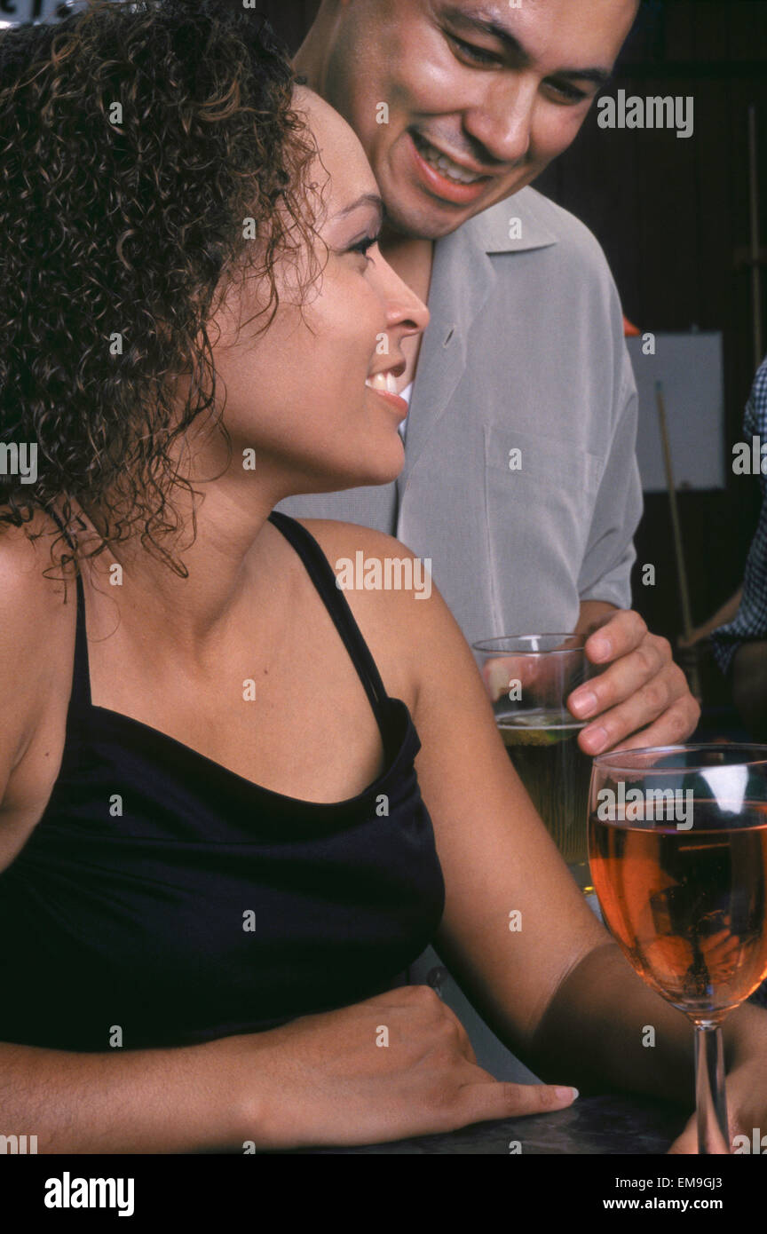 Couple drinking and socializing at bar Stock Photo - Alamy