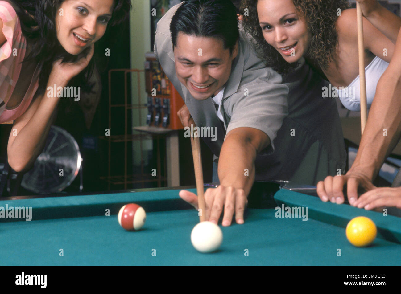 Group of friends playing game of pool at bar Stock Photo - Alamy