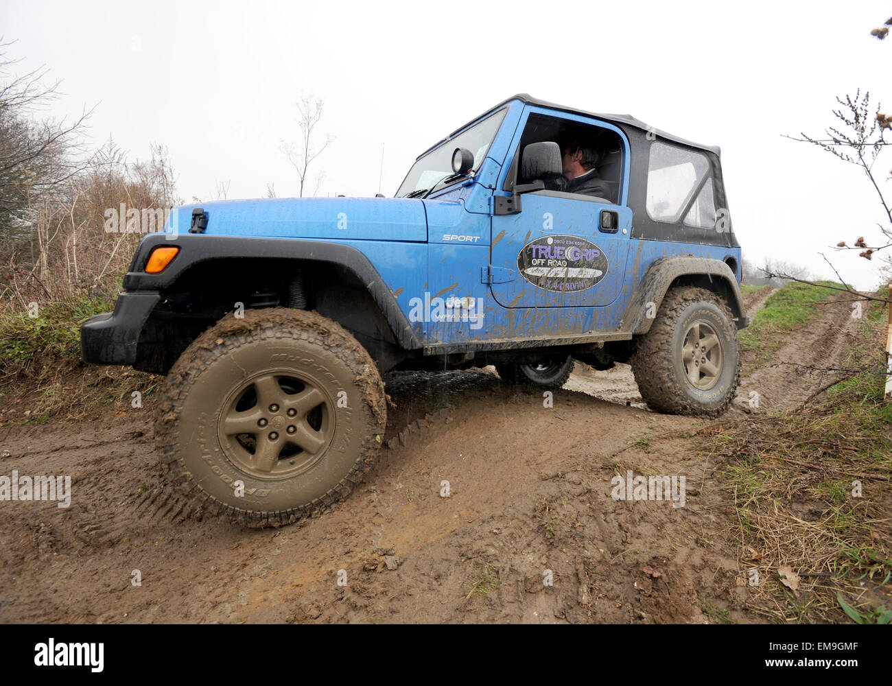Modified Jeep Wrangler driving off road in deep wet mud and water Stock ...