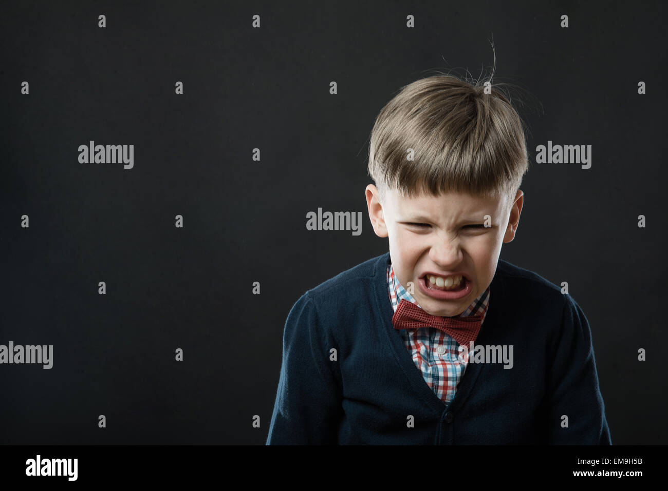 boy shouting loudly. studio shot, black background Stock Photo - Alamy