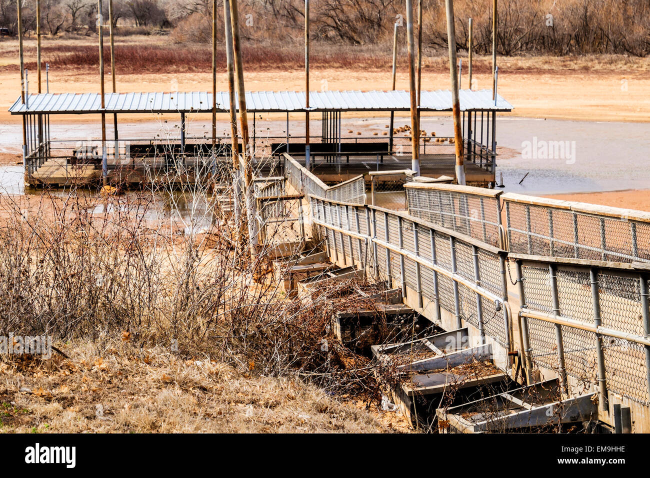 A fishing dock is left stranded in mud and low water in drought ...