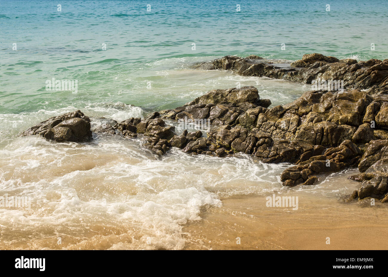 The waves breaking on a stony beach, forming a spray Stock Photo - Alamy