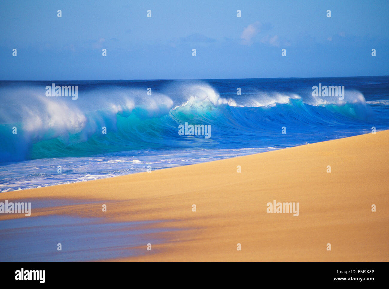 Shorebreak Waves Along Sandy Beach, Blue Sky Stock Photo - Alamy