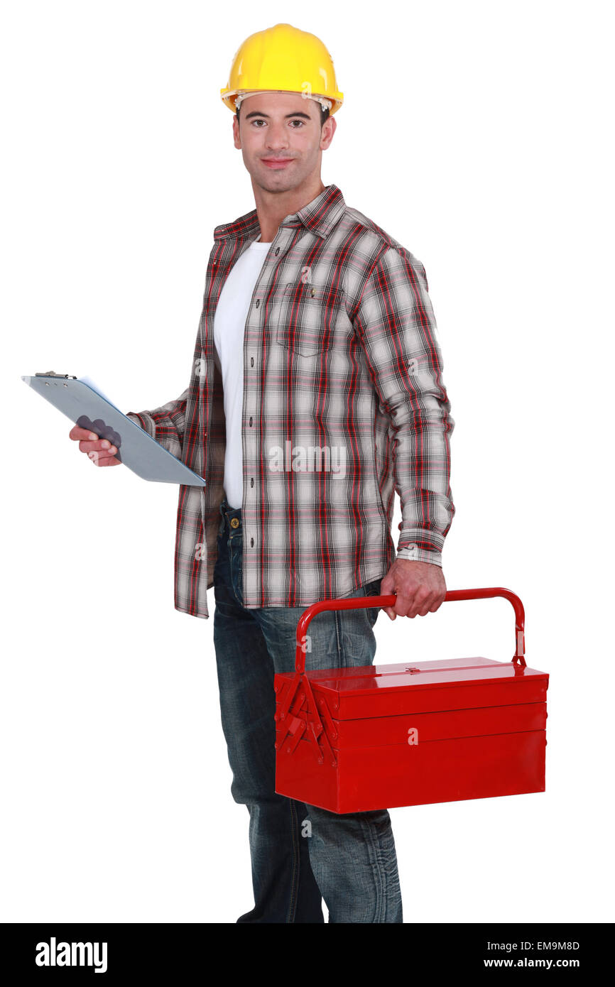 Builder holding clip-board and tool box Stock Photo - Alamy