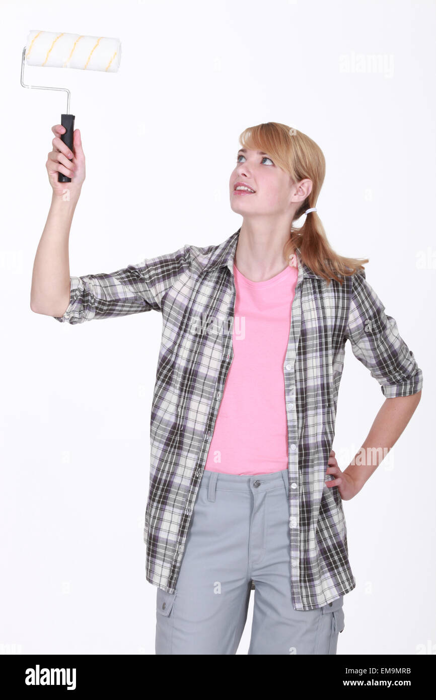 Woman using a paint roller Stock Photo - Alamy
