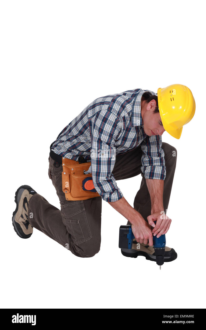 Man drilling hole in floor Stock Photo - Alamy