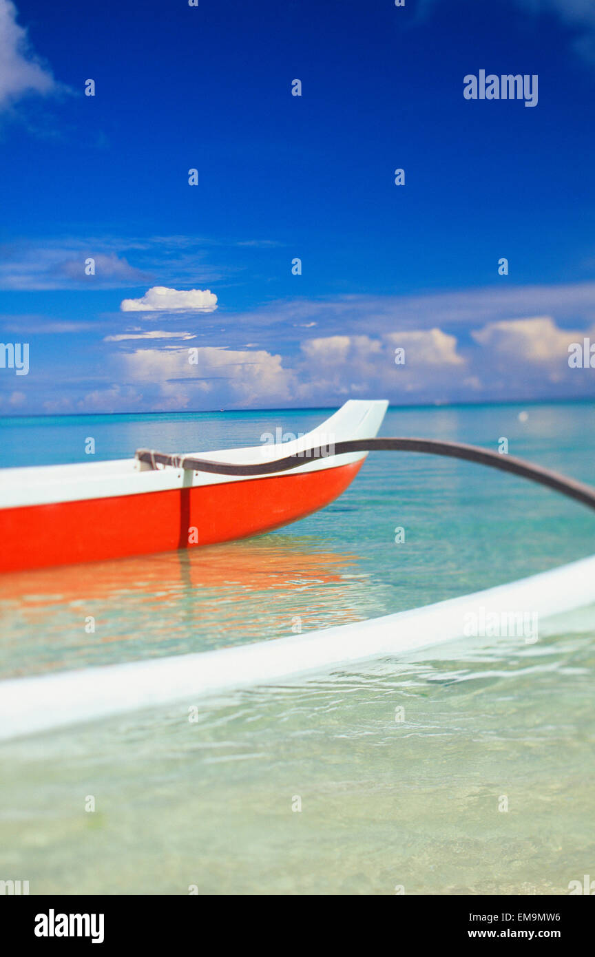Red And White Outrigger Canoe Floating On Calm Turquoise Water Stock ...