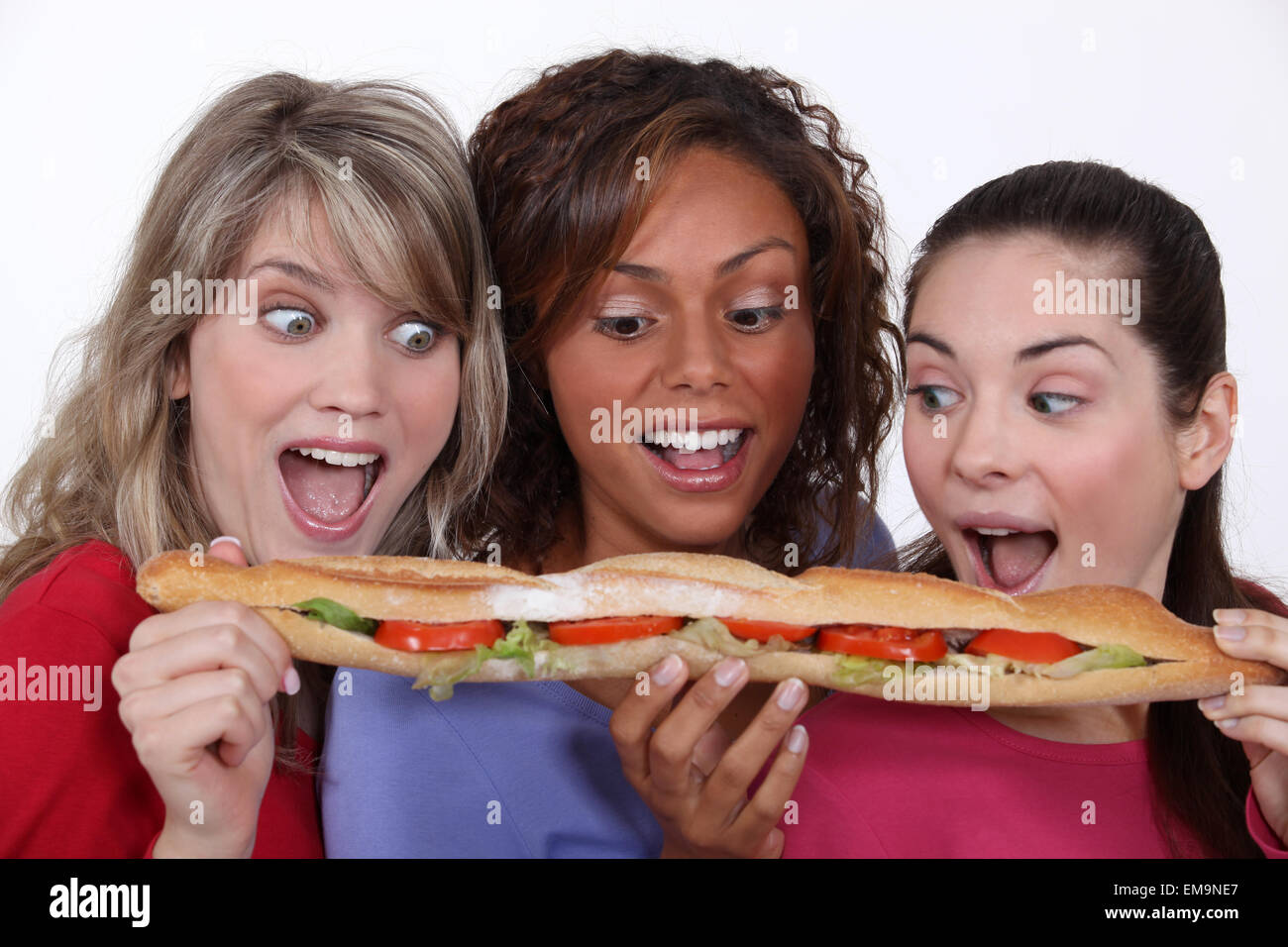 A group of friends eating a long sandwich Stock Photo - Alamy