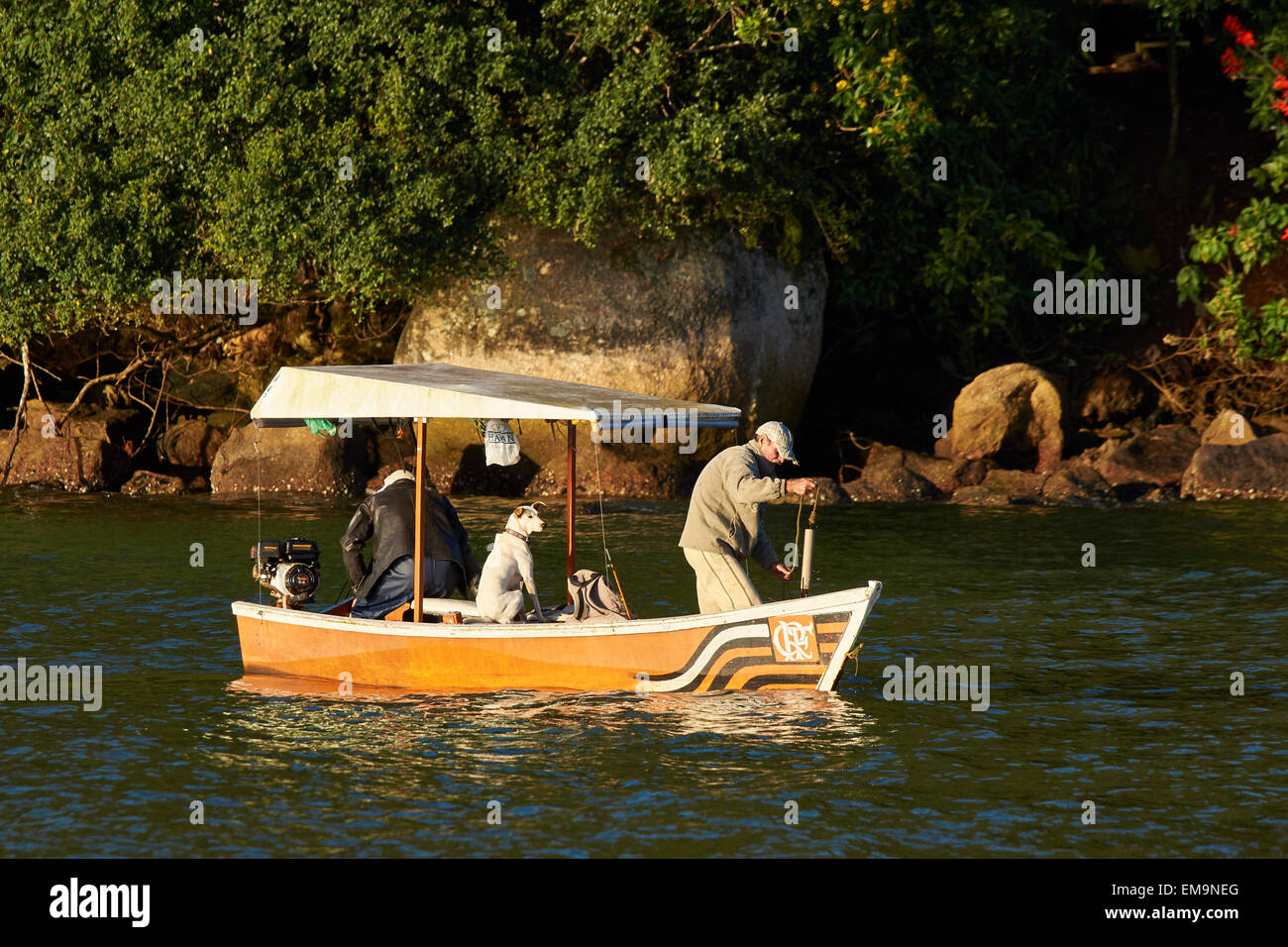 Fisherman with his best friends Stock Photo - Alamy