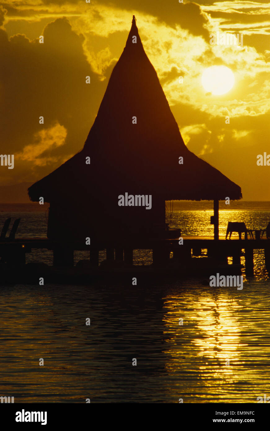 French Polynesia, Moorea, Silhouette Of Bungalow At Sunrise Stock Photo ...