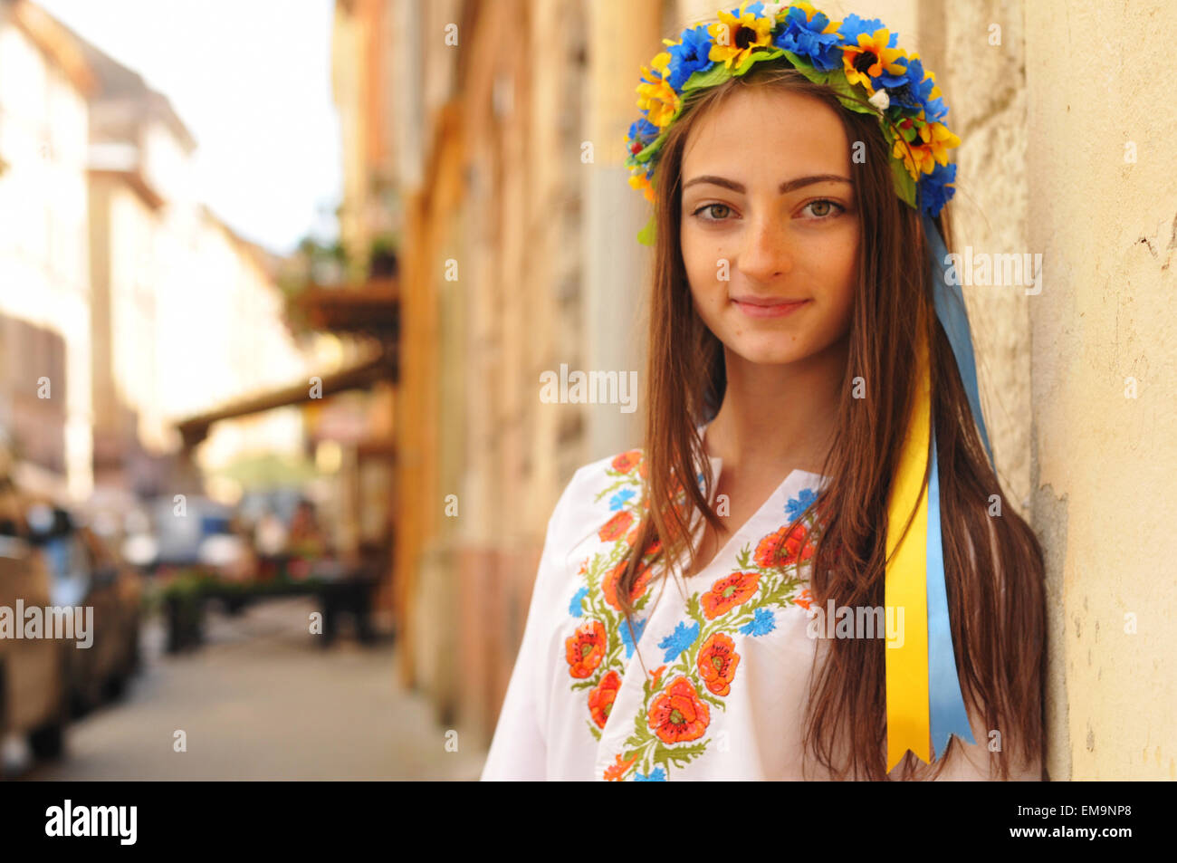 Pretty ukrainian girl stands and looking at camera. She is wearing ...