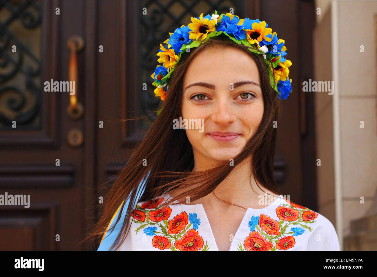 Pretty ukrainian girl stands and looking at camera. She is wearing ...