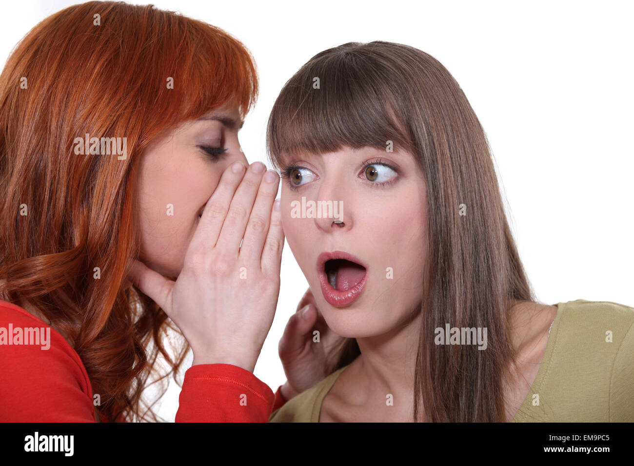 Girl whispering into teenage girls ear hi-res stock photography and ...