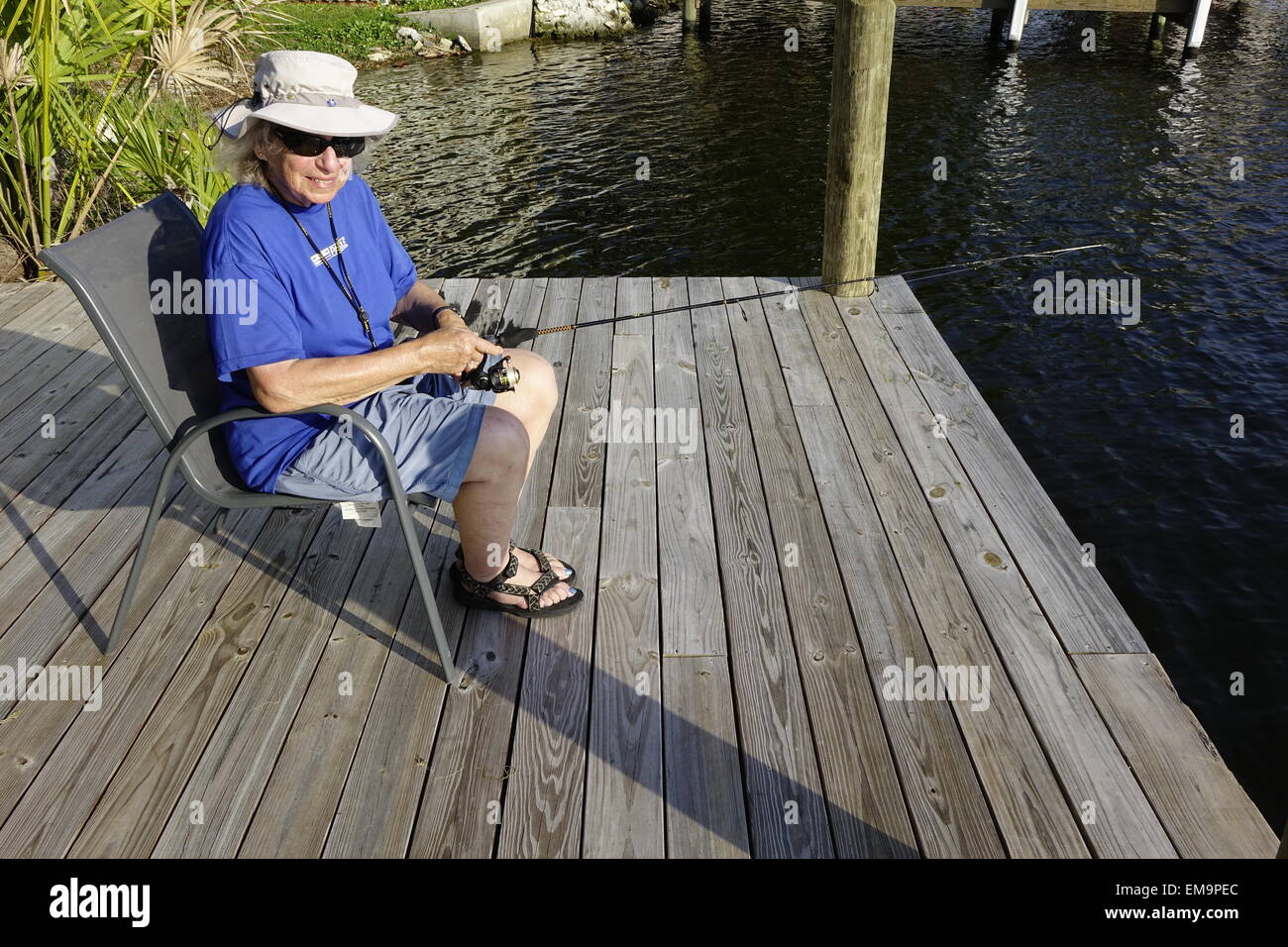 Woman fishing from dock, Homosassa River Stock Photo - Alamy