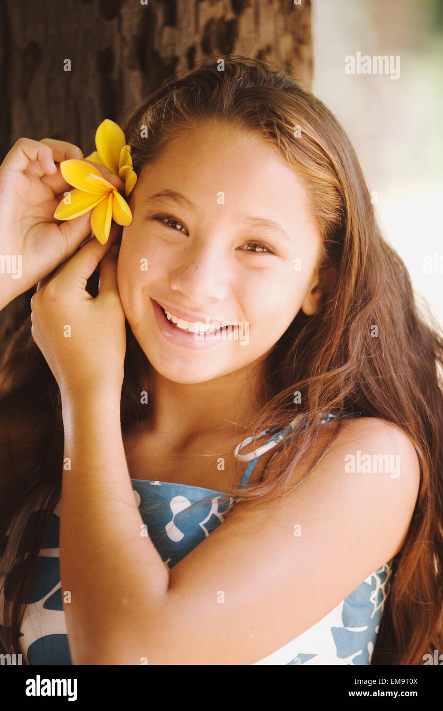 Young Hapa Hawaiian Girl Holding Flower Stock Photo - Alamy