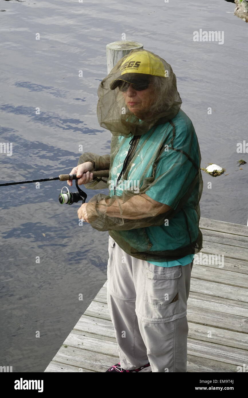 Woman wearing bug suit while fishing Stock Photo - Alamy