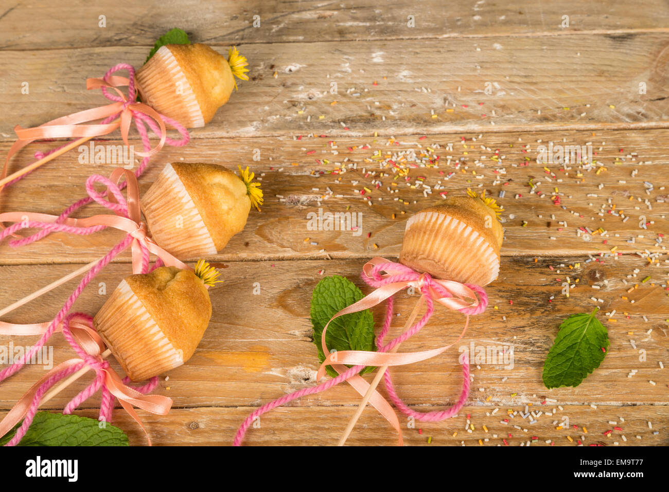 Fancily decorated muffins on a wooden table Stock Photo - Alamy
