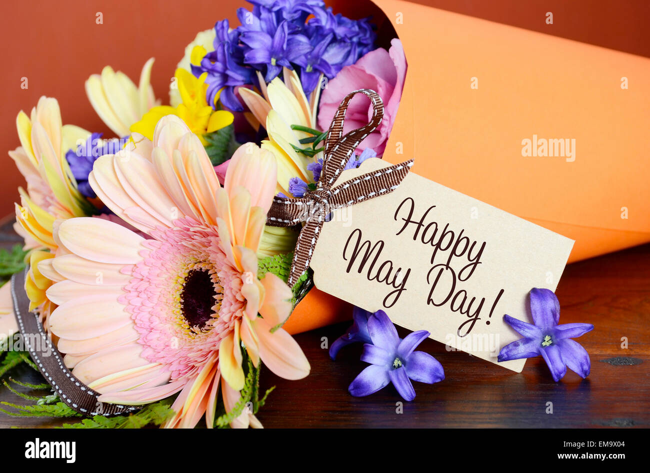 Happy May Day traditional gift of Spring Flowers in orange paper cone ...