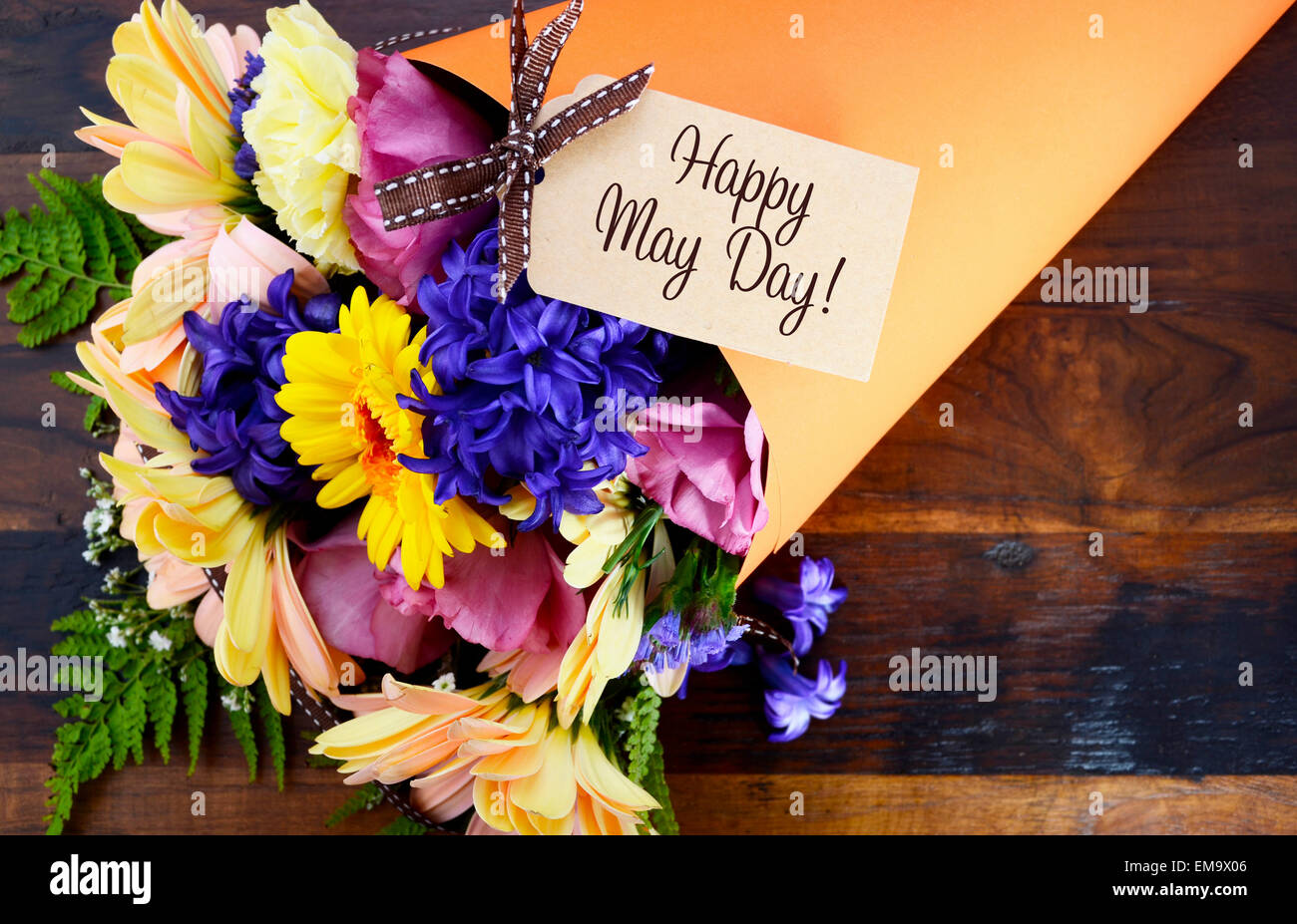 Happy May Day traditional gift of Spring Flowers in orange paper cone ...