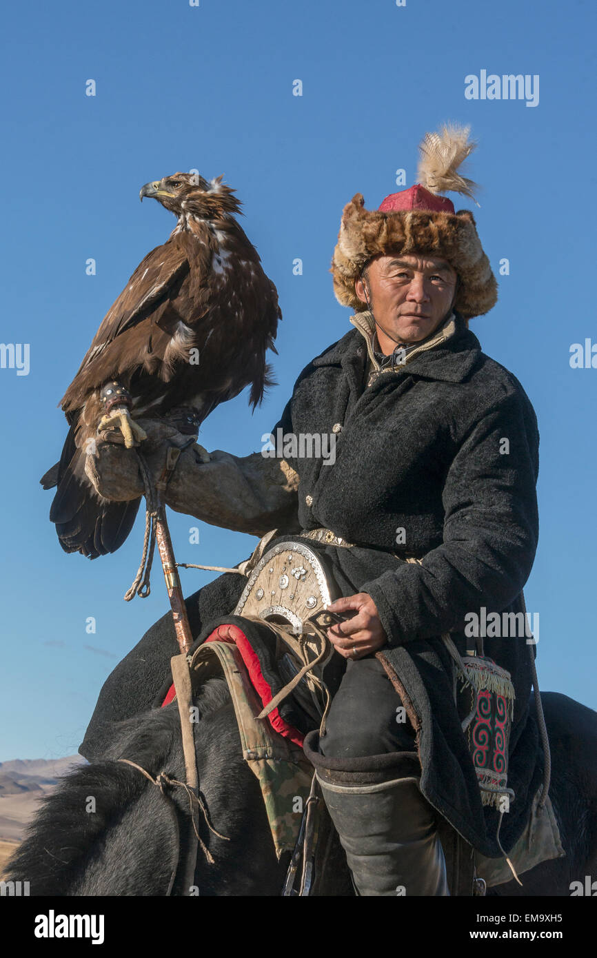 Portrait of an eagle trainer on his horse, with his golden eagle, near ...