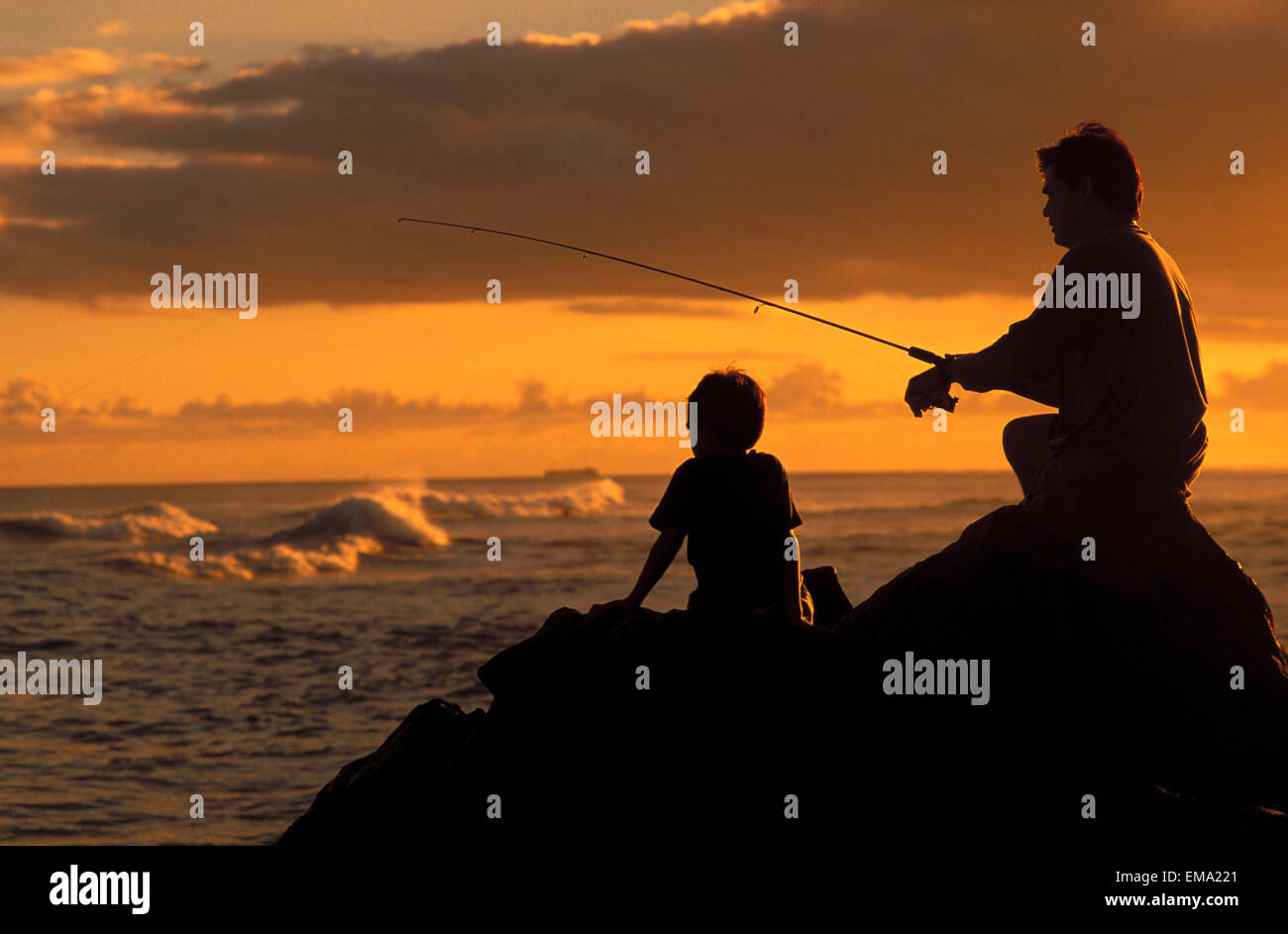 Local Family, Father And Son Fishing At Sunset With Dramatic Foreground ...