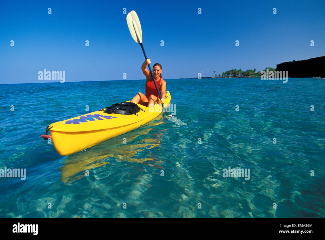 Female In Red Bathing Suit Paddling On Kayak In Crystal Clear Ocean Stock Photo - Alamy