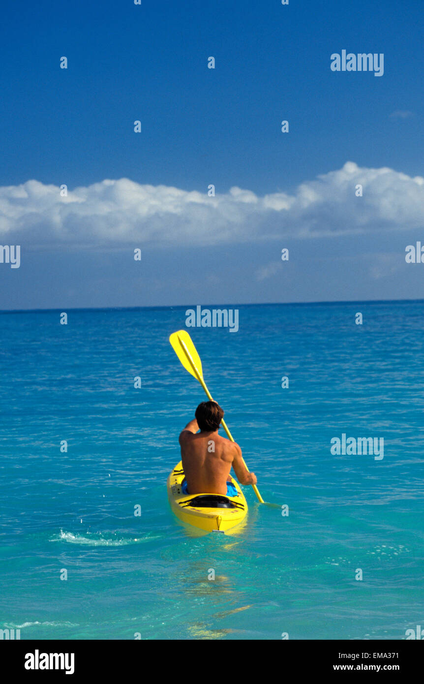Back View Of Man In Yellow Kayak, Paddle Raised, Bank Of White Clouds ...