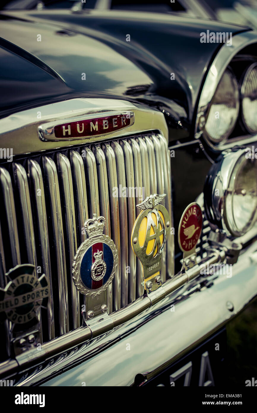 A vintage Humber vehicle grille is adorned with chrome badges of ...