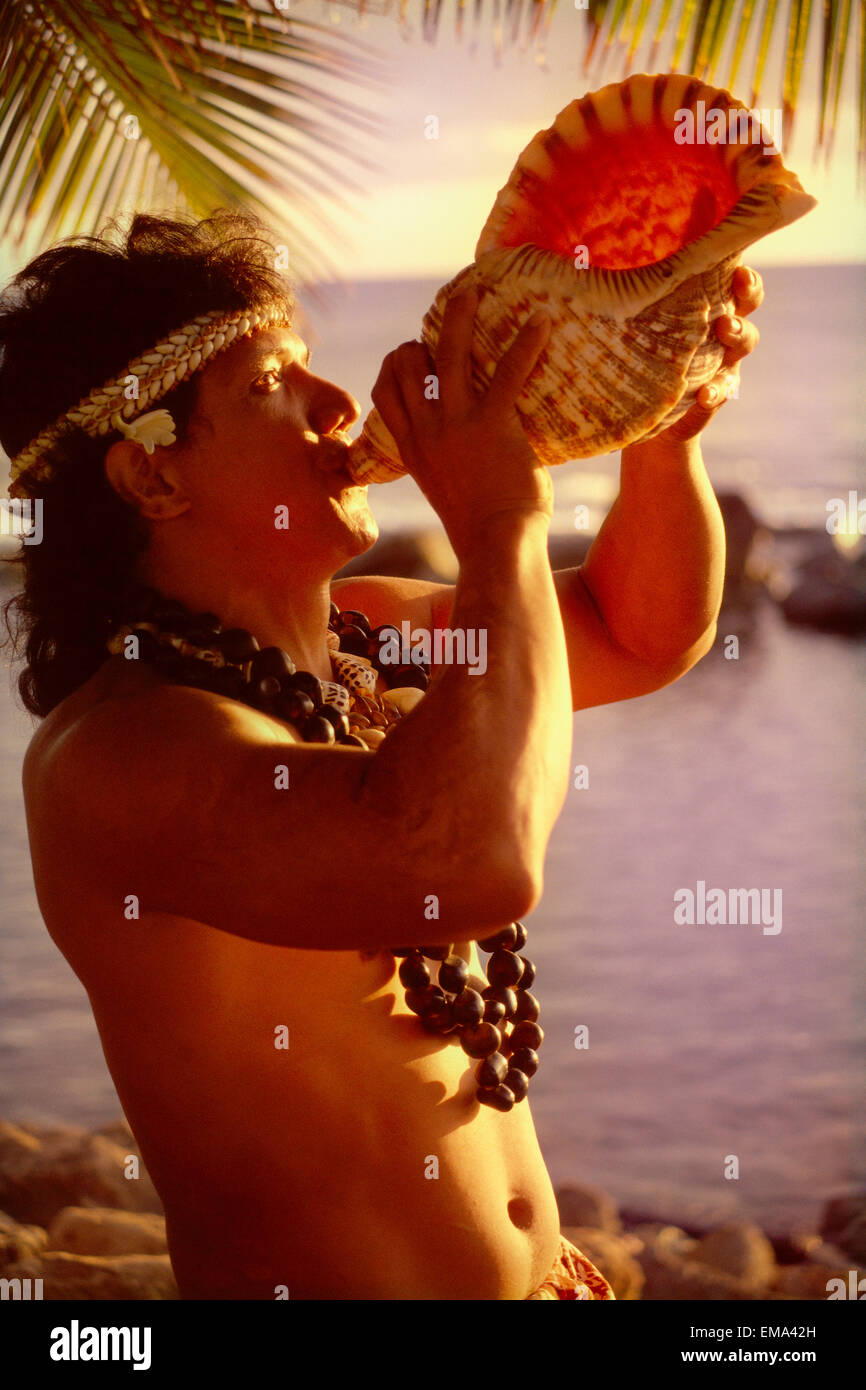 Hawaii, Close-Up Side Angle Of Male Conch Shell Blower, Kukui Nut Lei ...