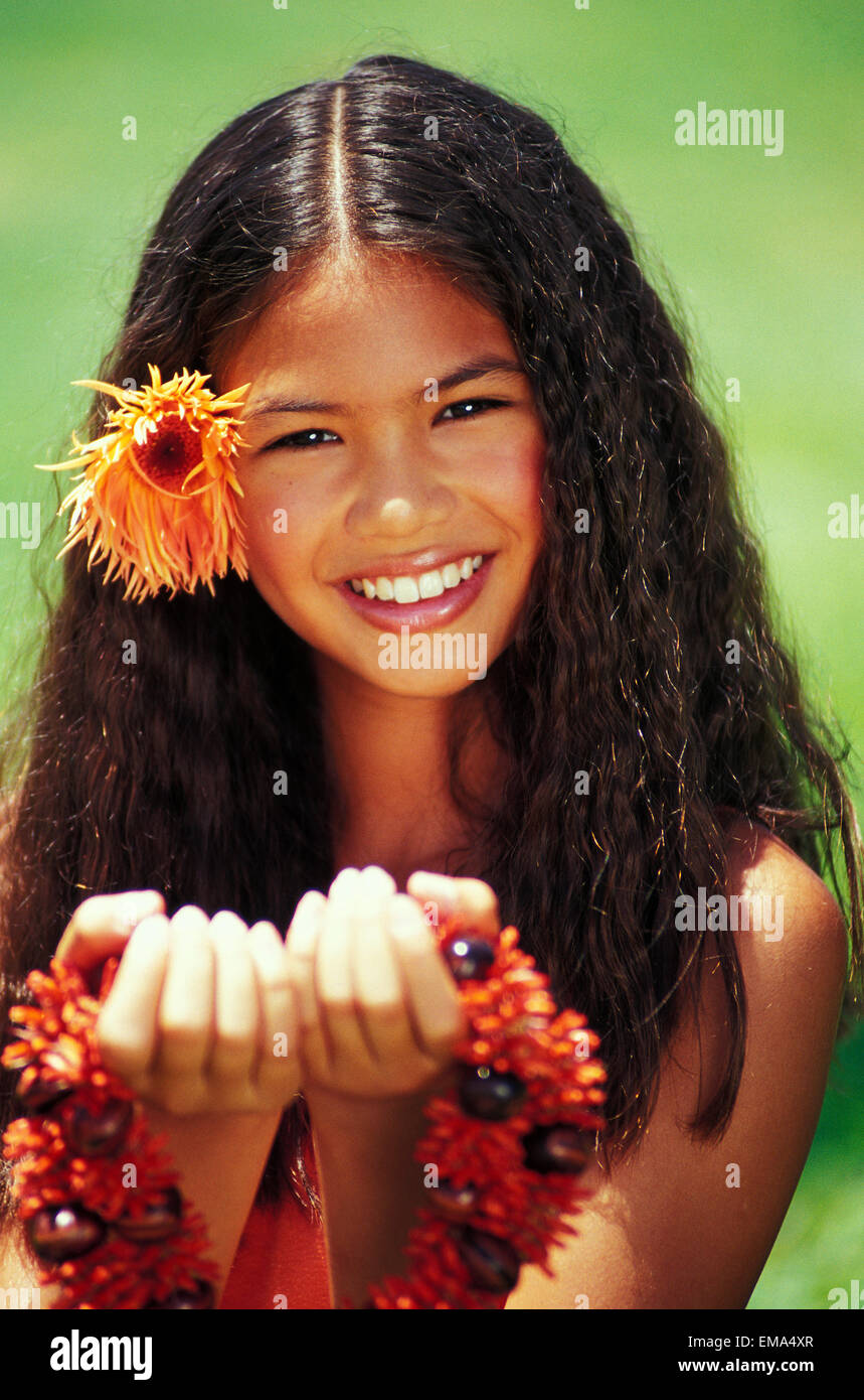 Young Hawaiian Girl Holding Up Orange Lei Stock Photo - Alamy