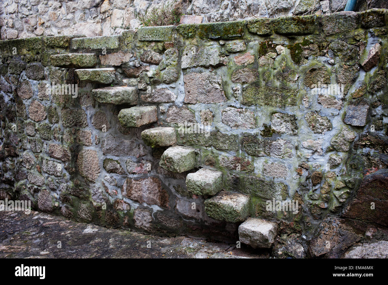 Old, narrow, medieval stone steps sticking out of a wall in the Old ...
