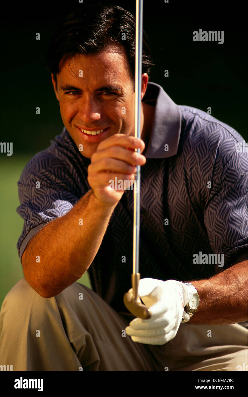 Man Sizes Up Putt With Golf Club Stock Photo - Alamy