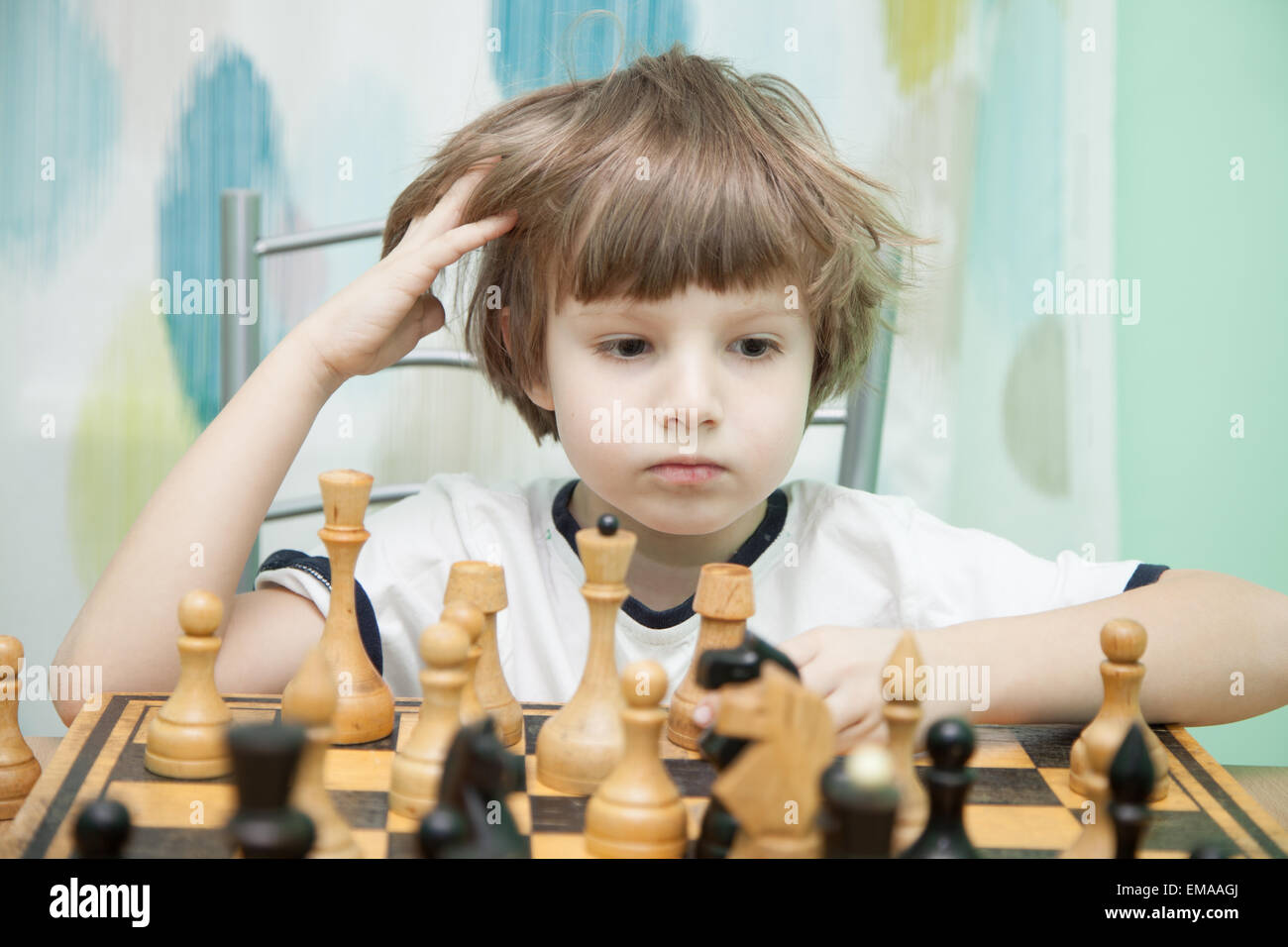Portrait of a little boy playing chess Stock Photo - Alamy
