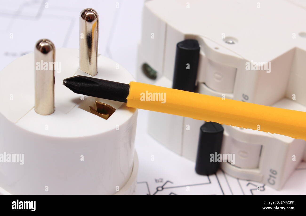 Screwdriver, work tools, electric plug and fuse lying on construction ...
