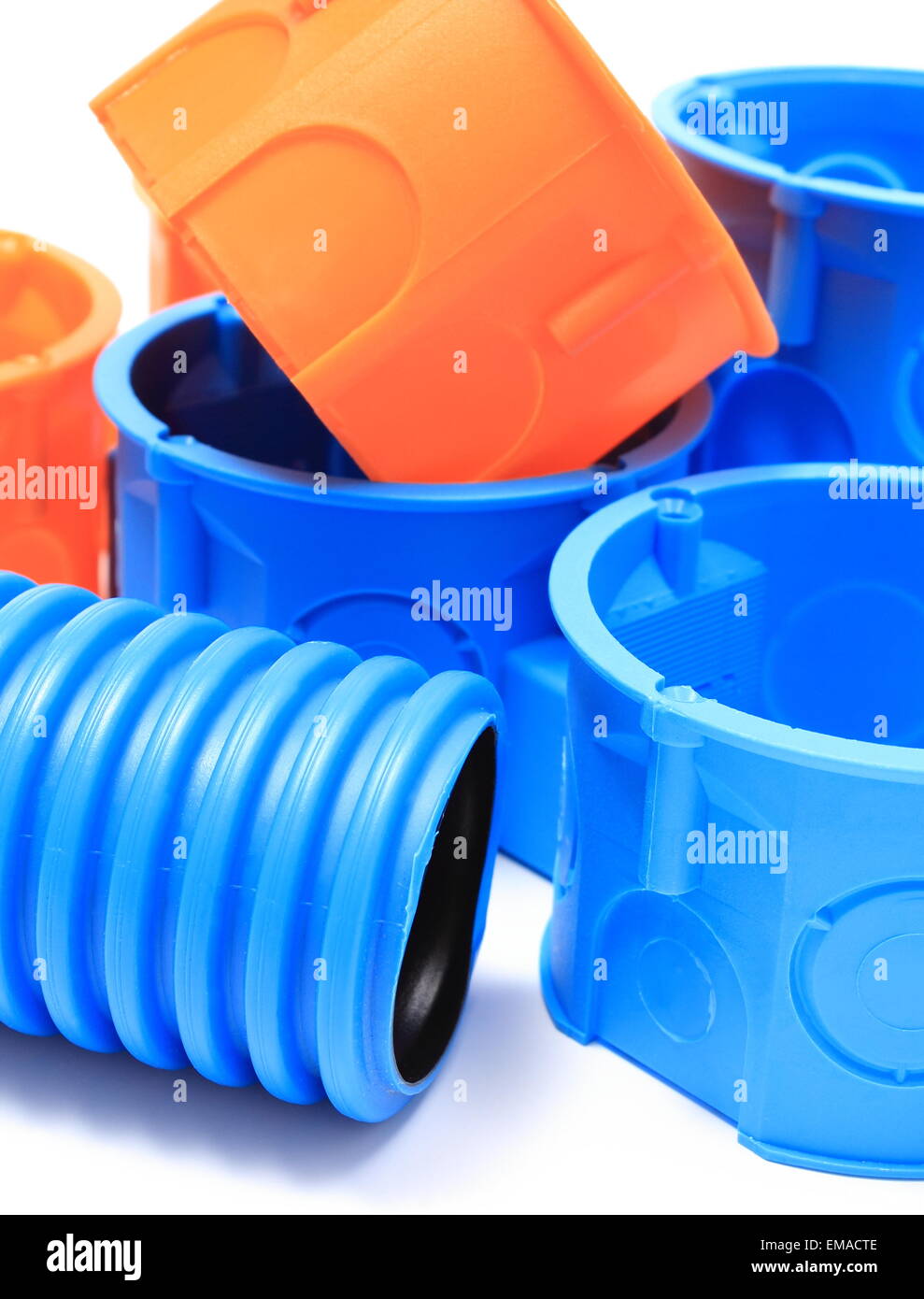 Heap of blue and orange electrical boxes with components for use in ...