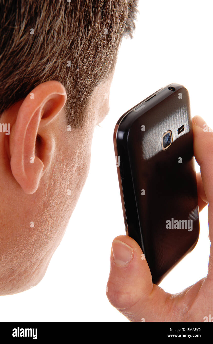 A closeup shoot of a man from the back holding his cell phone on his ...