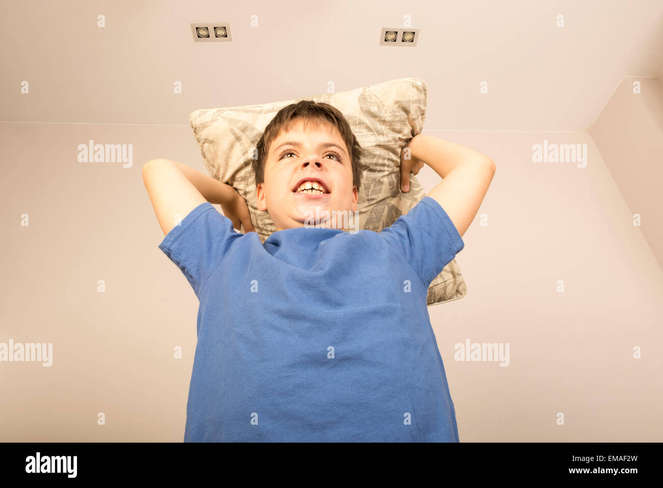 Young boy going to throw a pillow Stock Photo - Alamy