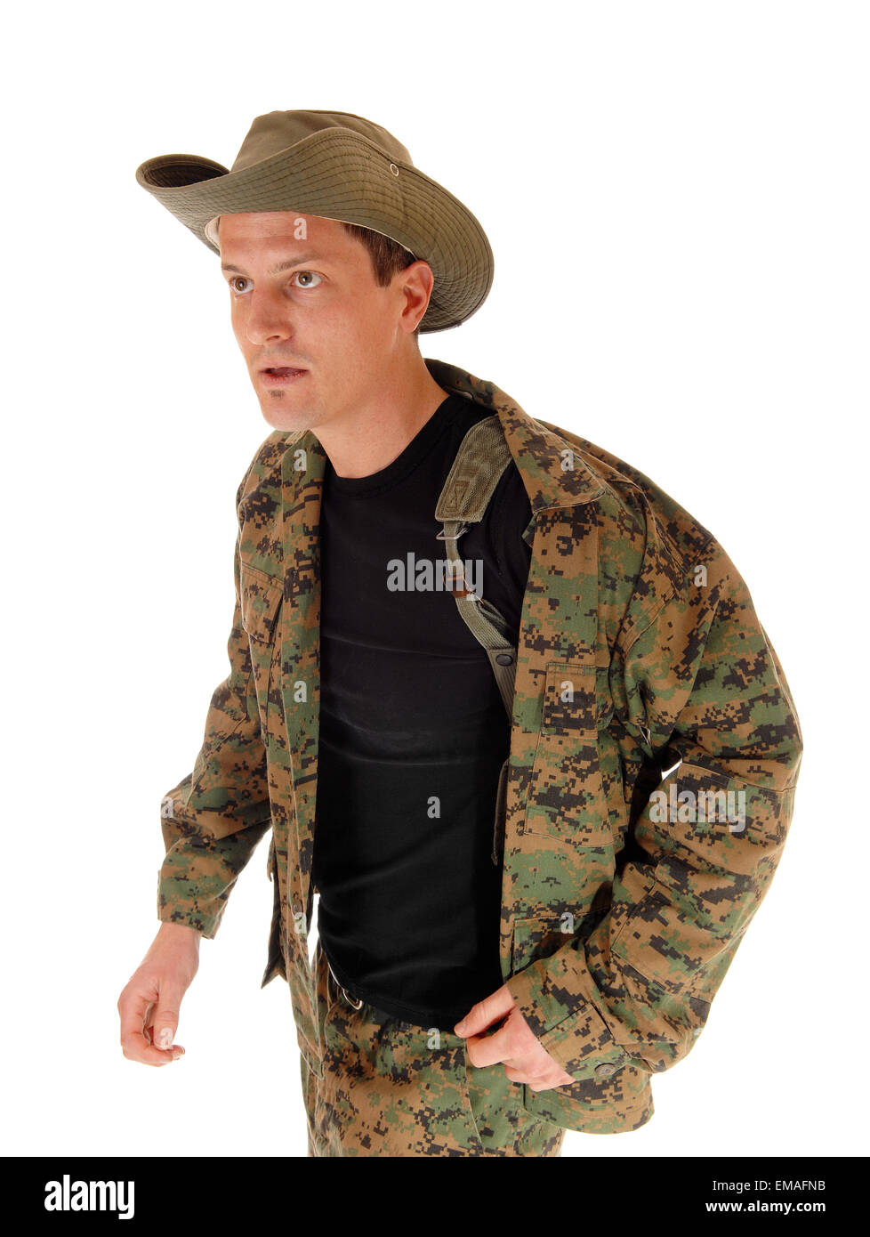 A young soldier in a camouflage uniform and olive green hat looking ...