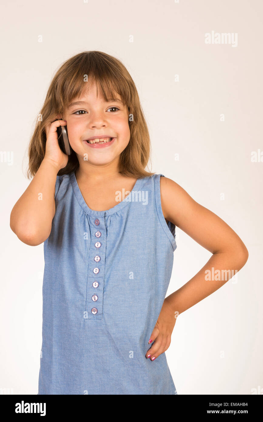 happy girl standing talking on cellphone with white background Stock ...
