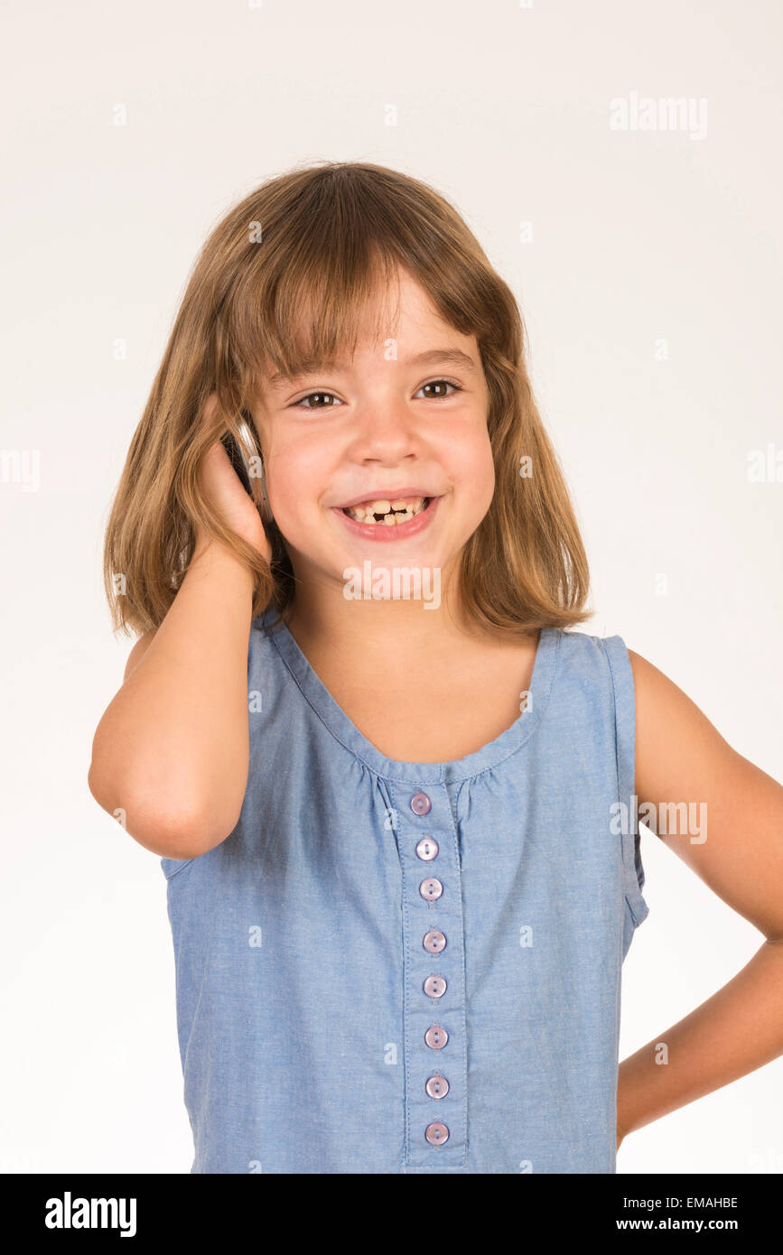 happy girl standing talking on cellphone with white background Stock ...