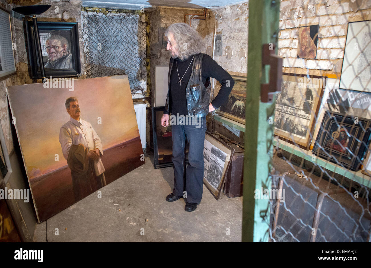 Eugen Posin, one of the three Posin brothers, poses next to a painting ...