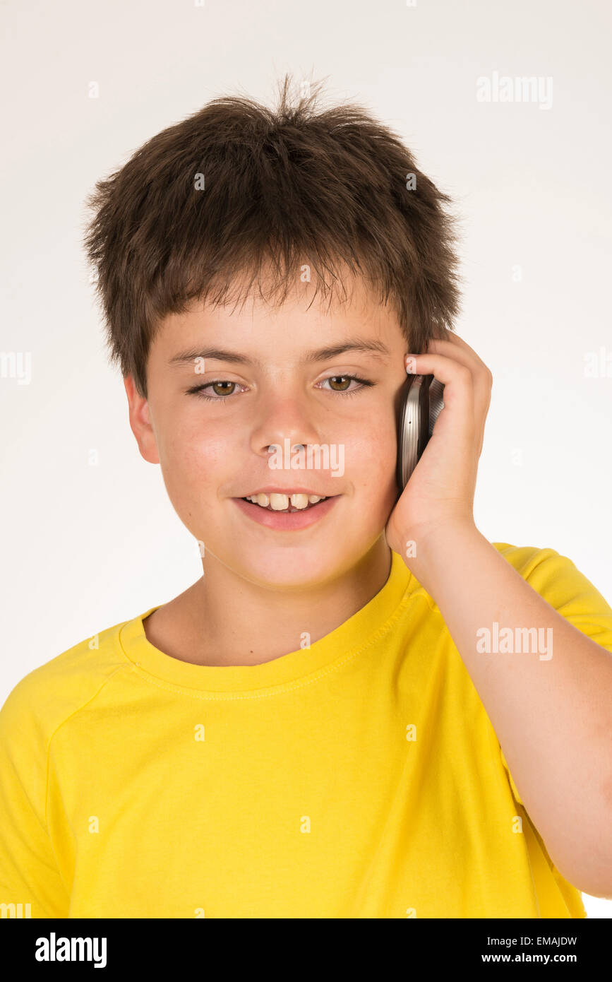 Young boy talking with mobile isolated on white background Stock Photo ...