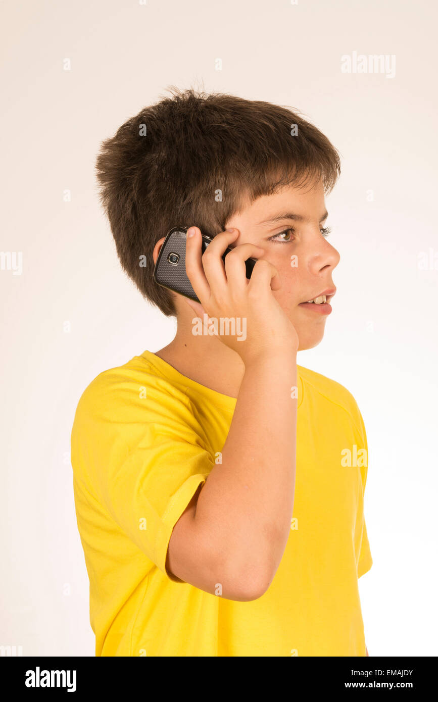 Young boy talking with mobile isolated on white background Stock Photo ...