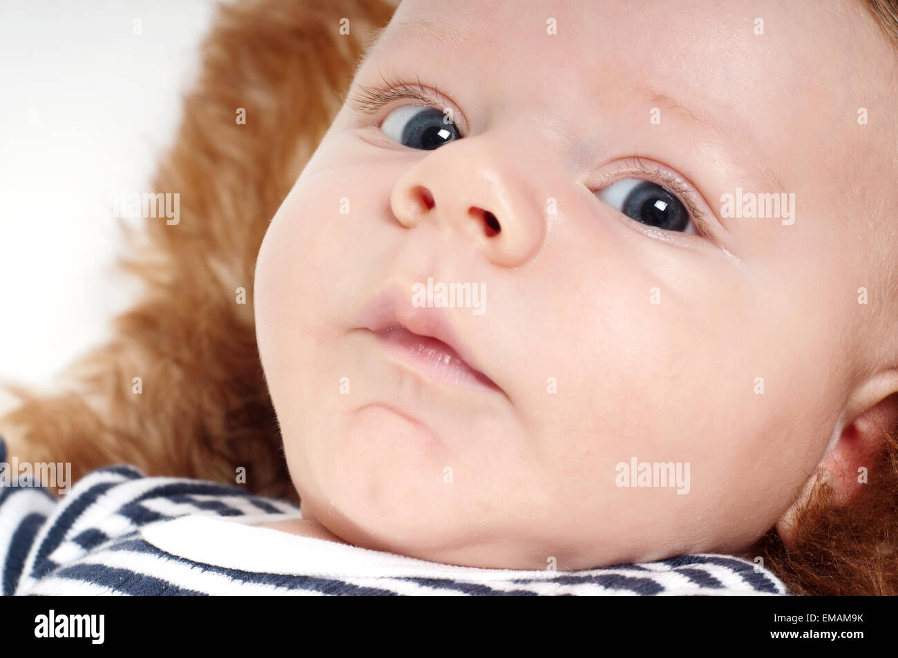 Portrait of adorable child lying on fur Stock Photo - Alamy